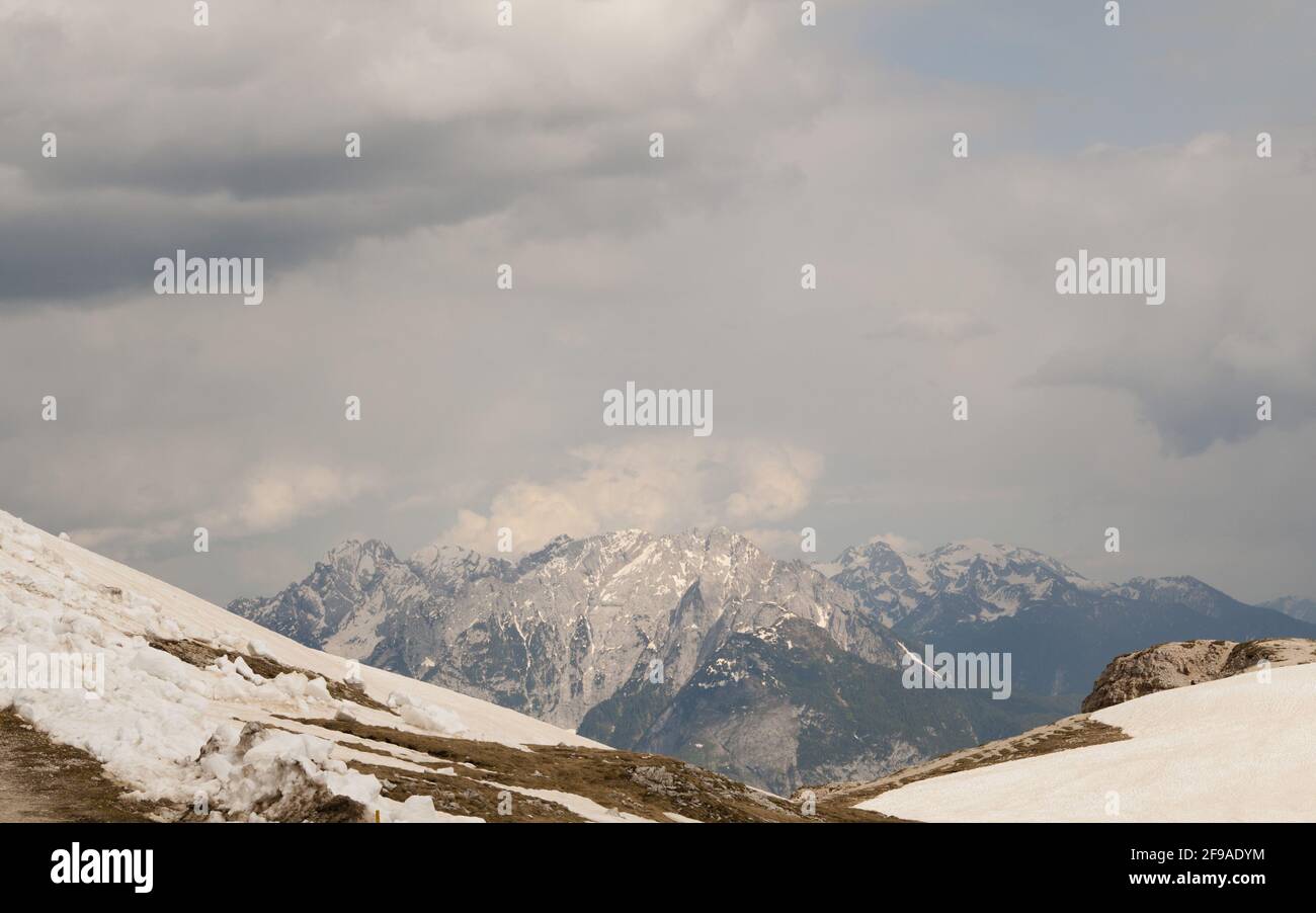 Beautiful view of a snow-covered mountain range with peaks in clouds ...