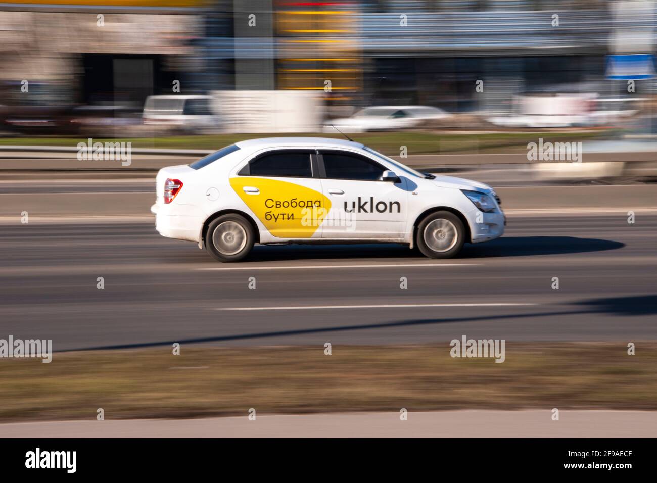 Ukraine, Kyiv - 3 March 2021: White Taxi Uklon car moving on the street ...