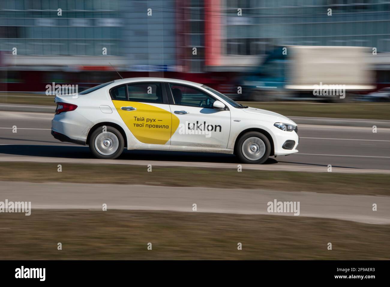 Ukraine, Kyiv - 3 March 2021: White Taxi Uklon car moving on the street ...