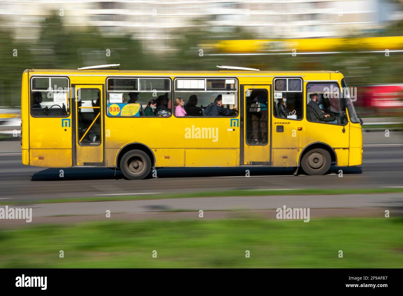 Ukraine, Kyiv - 10 December 2020: Yellow Public bus Ataman moving on ...