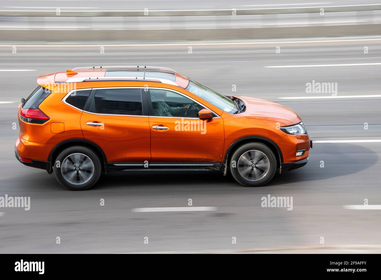 Ukraine, Kyiv - 29 September 2020: Orange Nissan Rogue car moving on ...