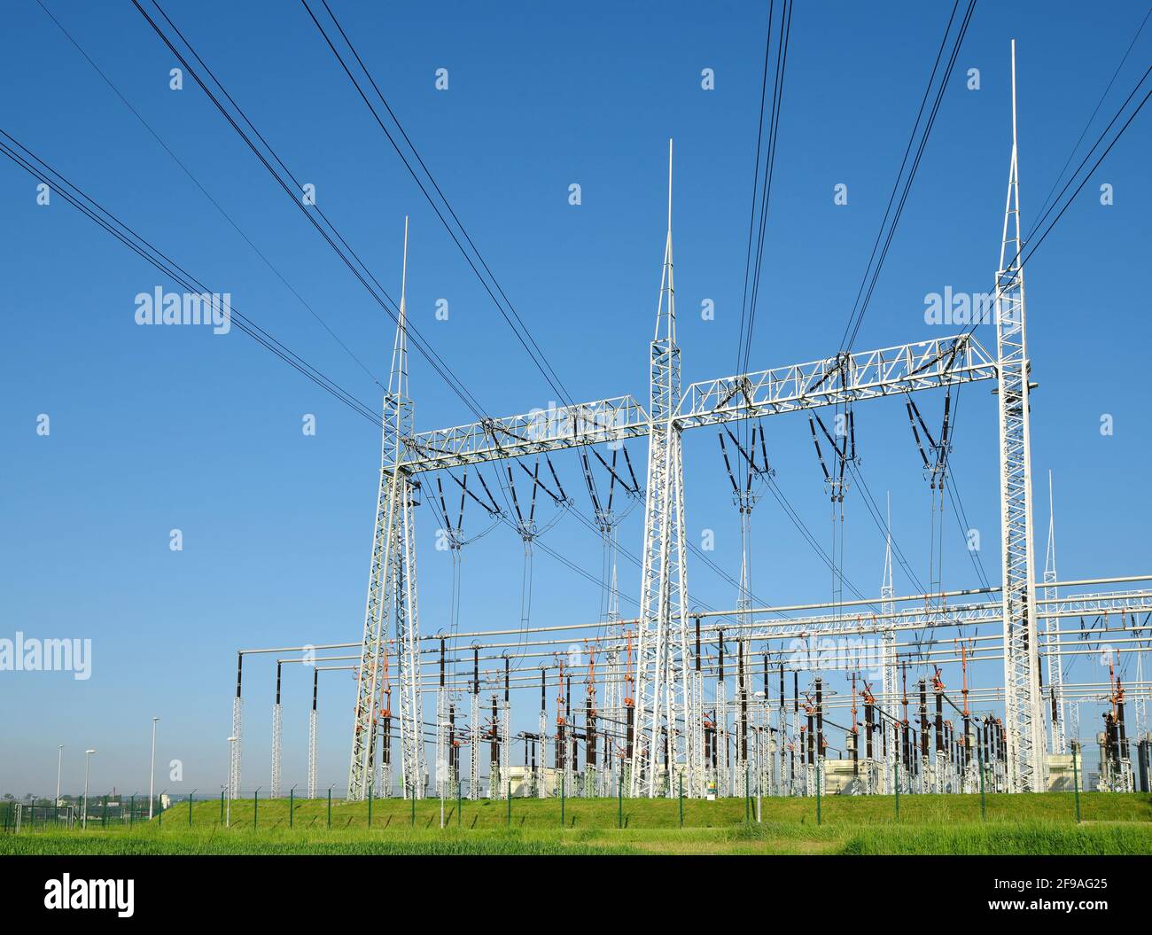 High voltage power substation on blue sky background Stock Photo - Alamy