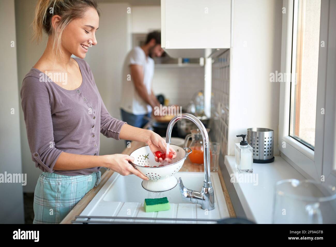 caucasian adult couple having fun in the kitchen Stock Photo - Alamy