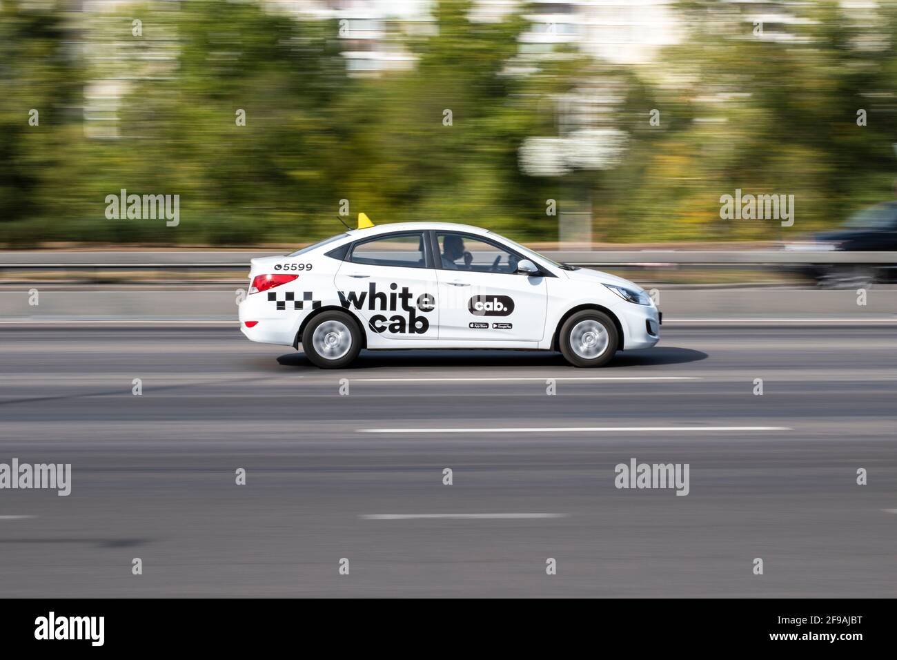 Ukraine, Kyiv - 24 September 2020: White Cab taxi car moving on the ...