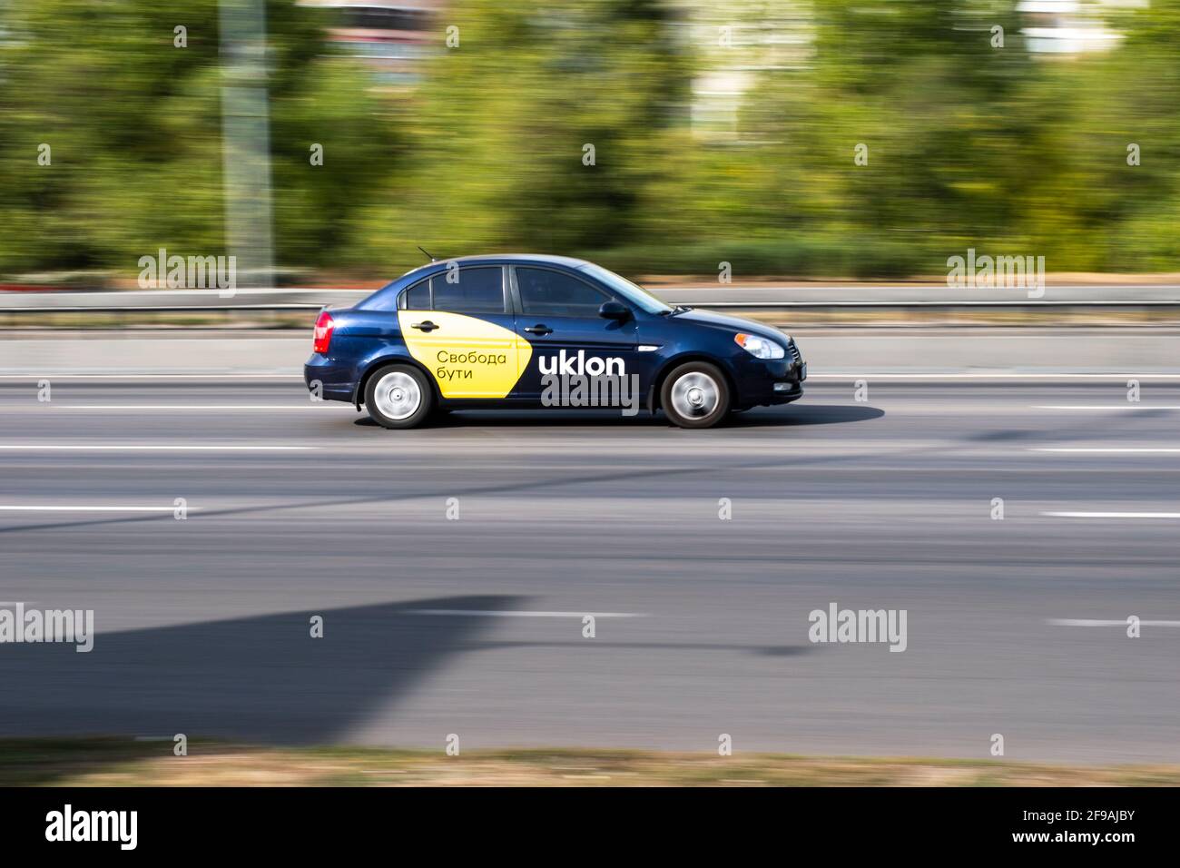 Ukraine, Kyiv - 24 September 2020: Uklon taxi car moving on the street ...