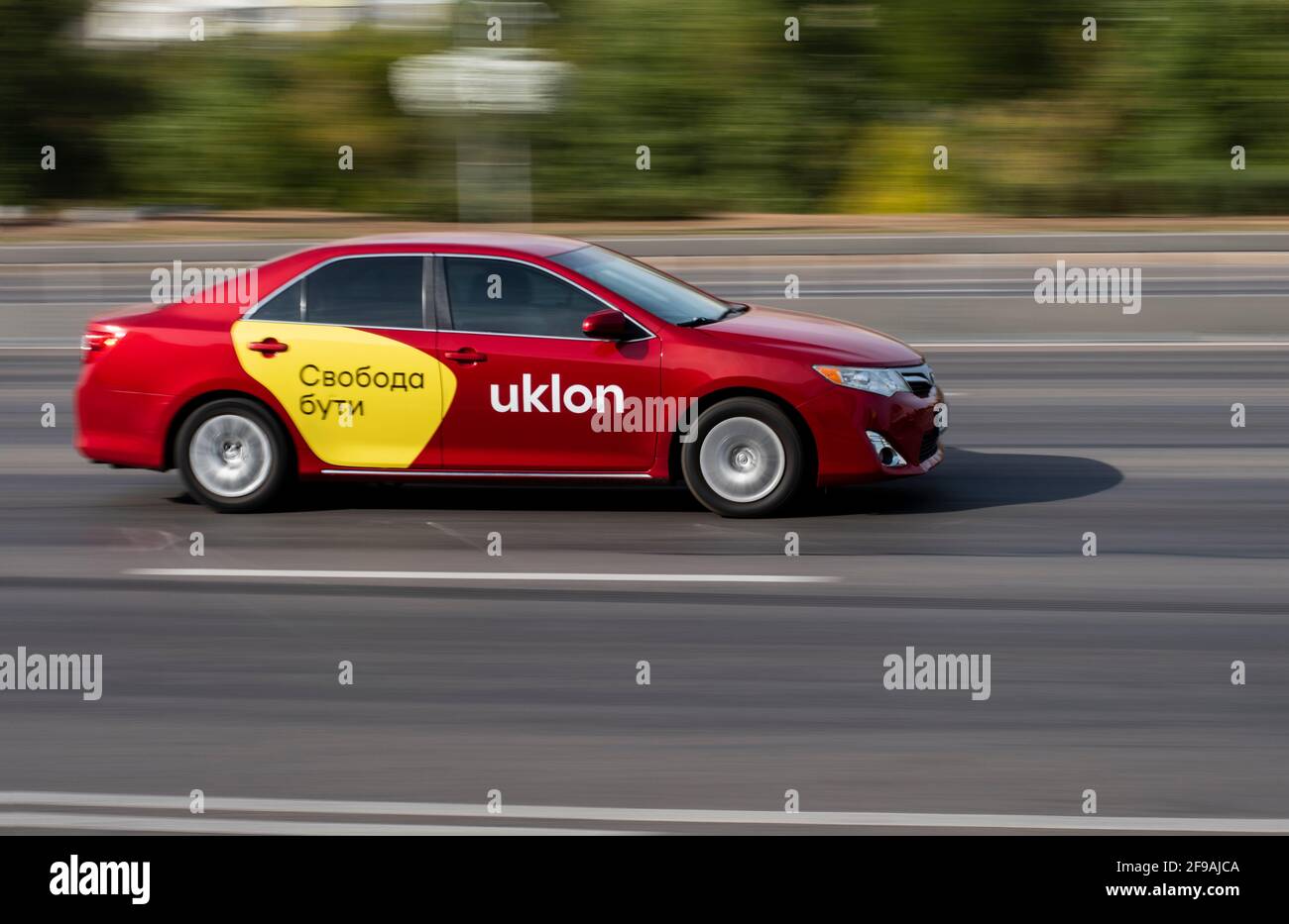 Ukraine, Kyiv - 24 September 2020: Uklon taxi red car moving on the ...