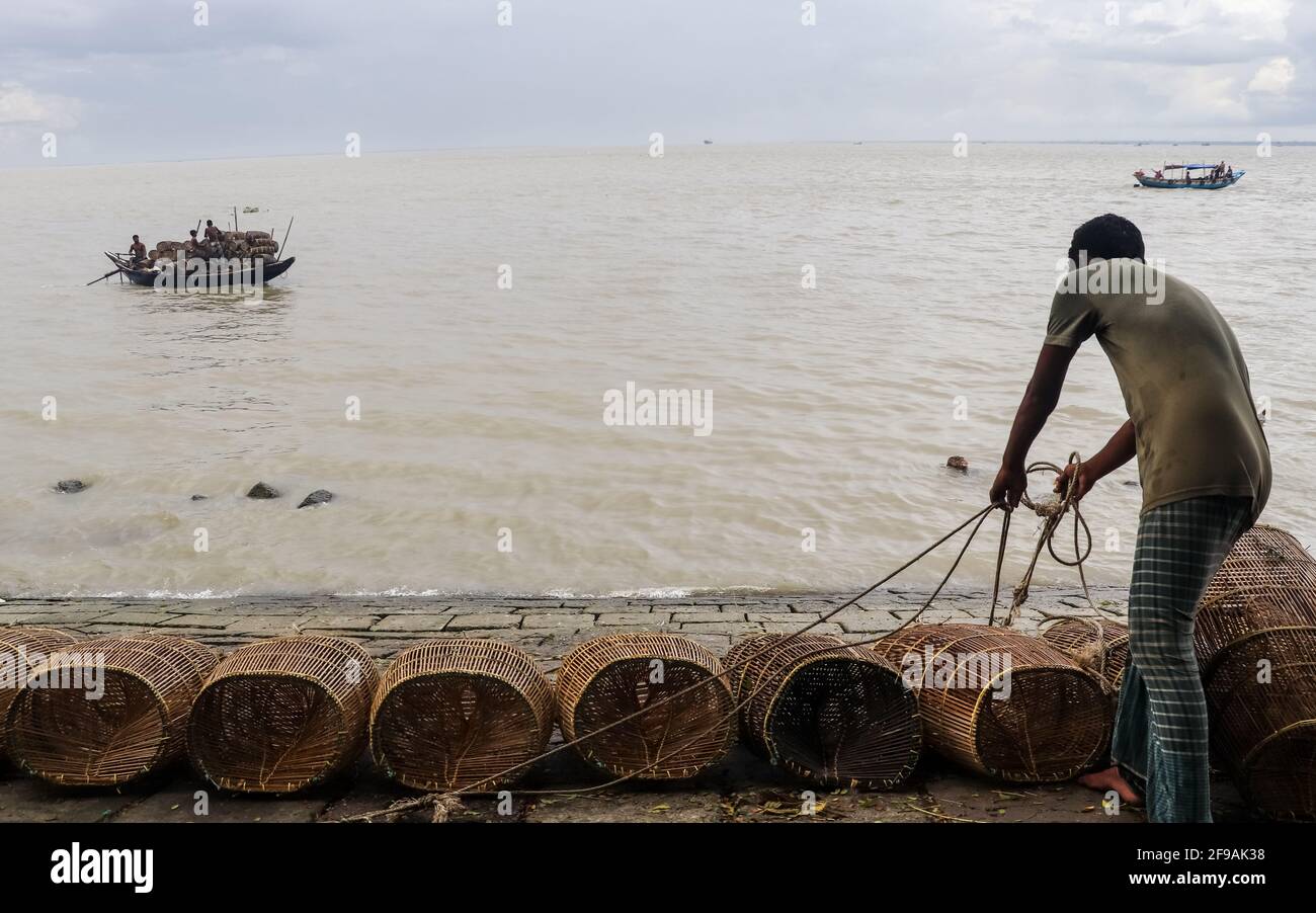 Fisherman taking preparation for fishing by cage and rope on the ...