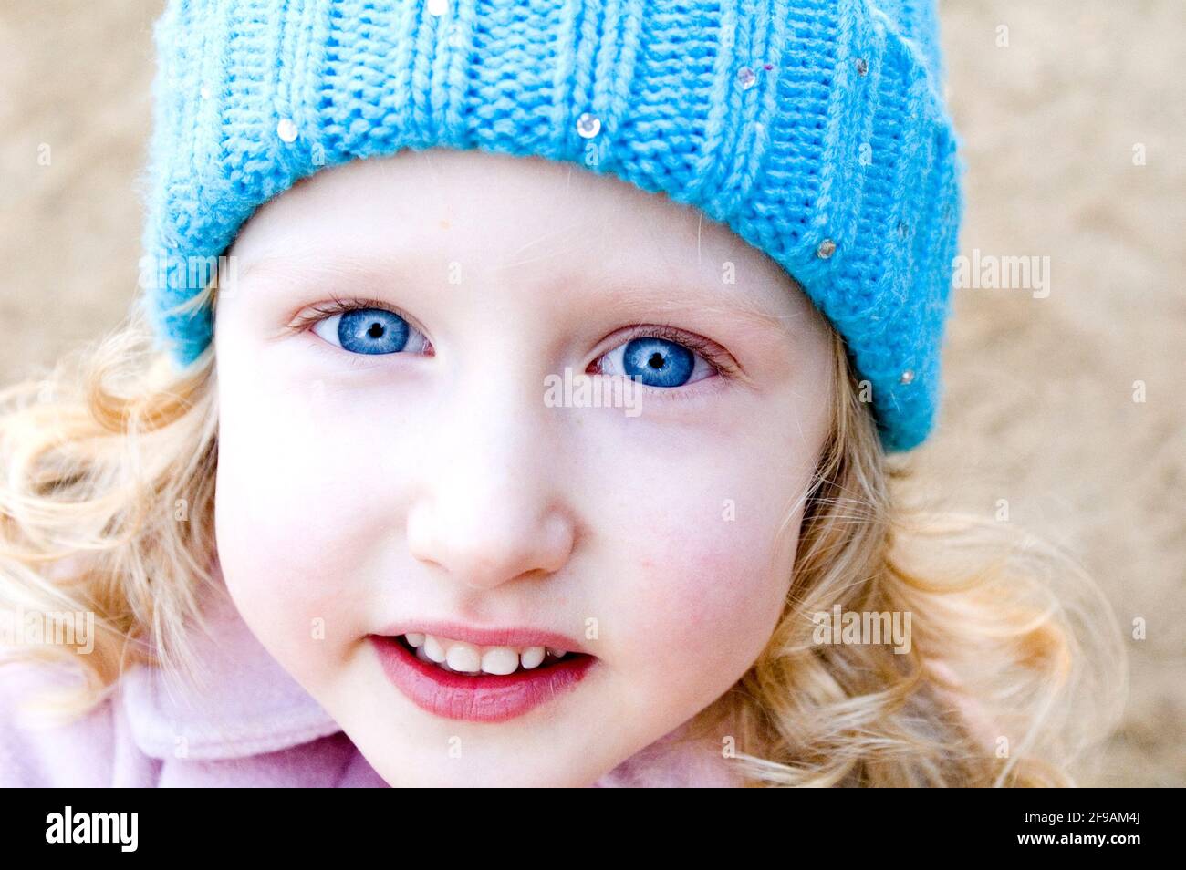 Toddler looks into camera, blonde girl, close-up, series of portraits ...