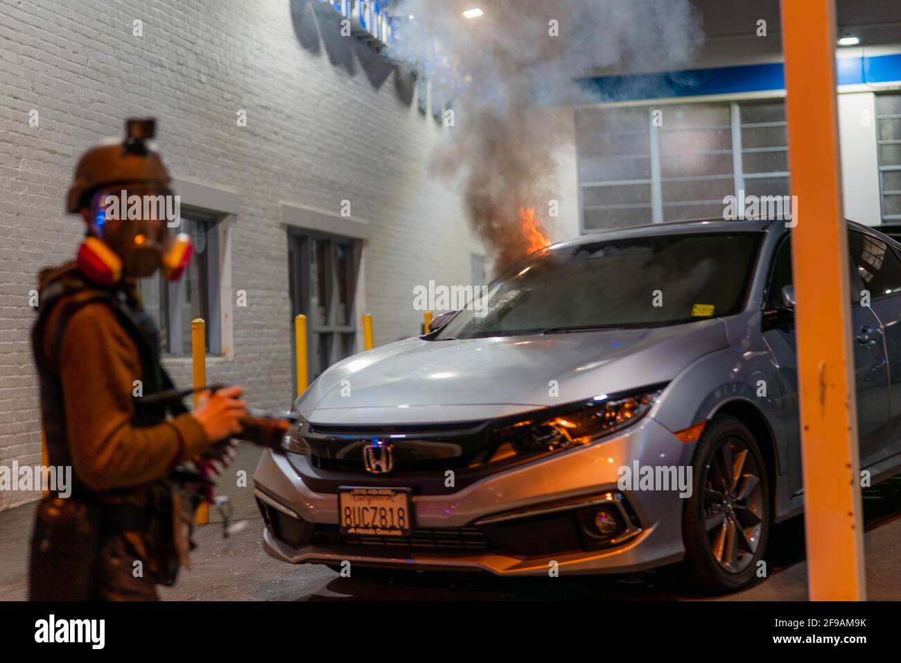 Oakland, CA, USA. 16th Apr, 2021. A car burns at a Honda dealership as ...