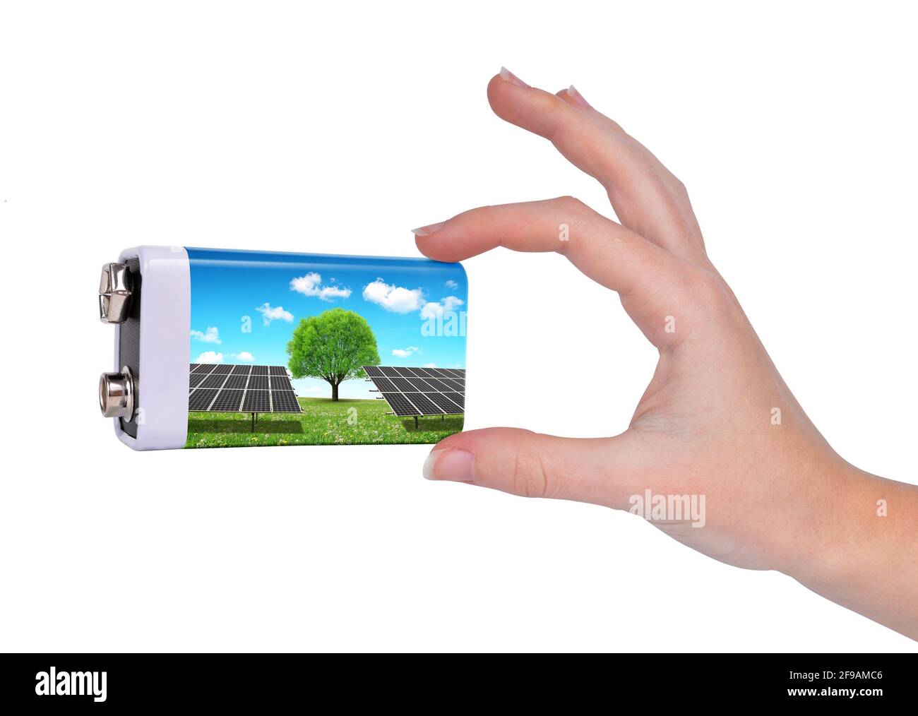 Hand holding battery with solar panels isolated on white background ...