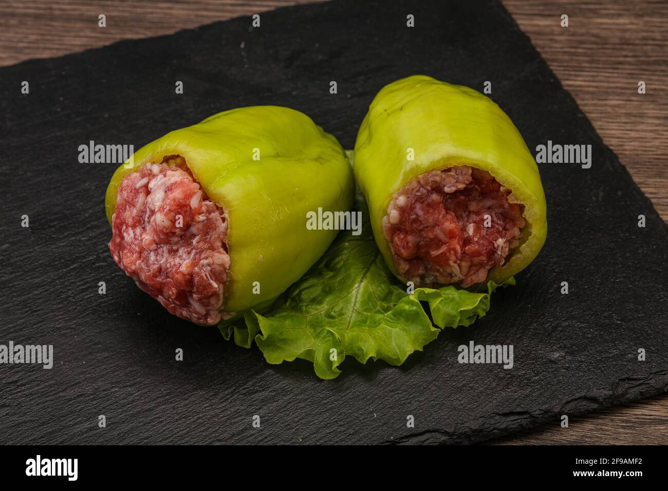 Raw stuffed green bell pepper with meat Stock Photo - Alamy