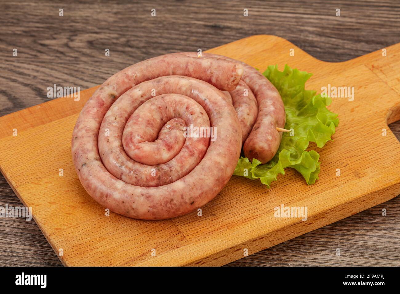 Raw pork sausage ring for grill Stock Photo - Alamy