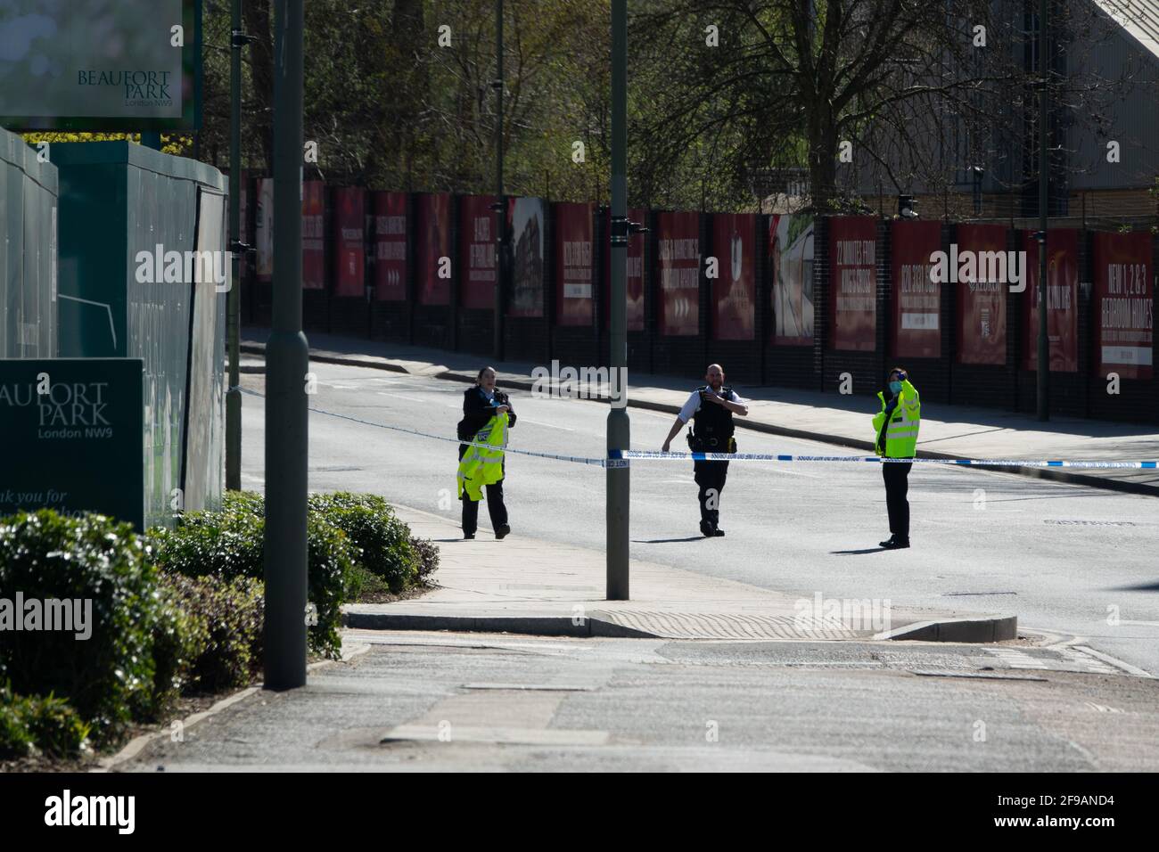 Three police officers standing in the middle of the road at a police ...