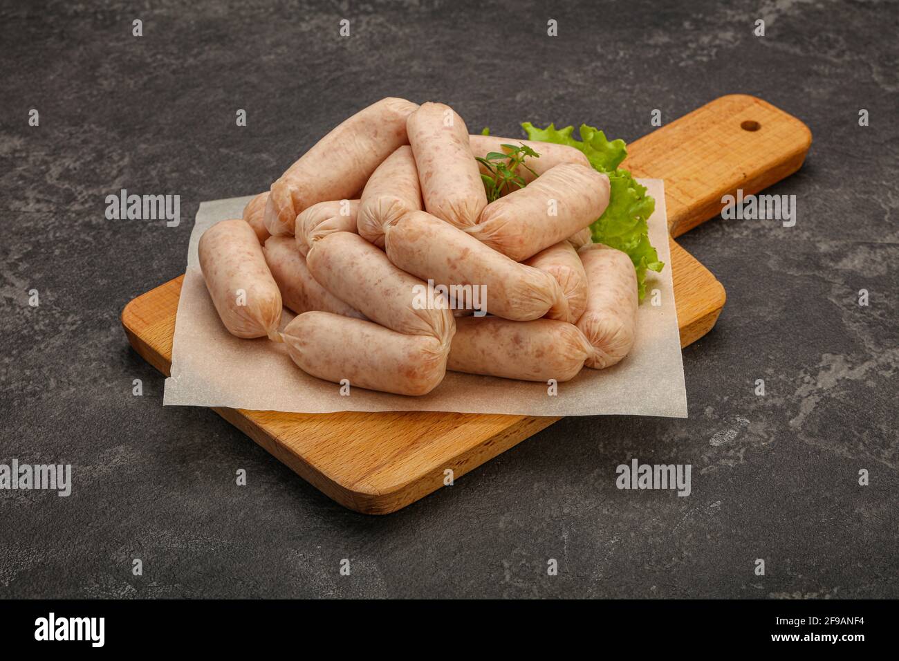 Raw natural chicken baby sausages for roast Stock Photo - Alamy