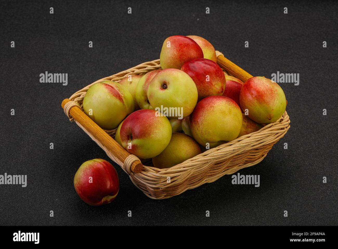 Sweet small green nectarines in the basket Stock Photo - Alamy