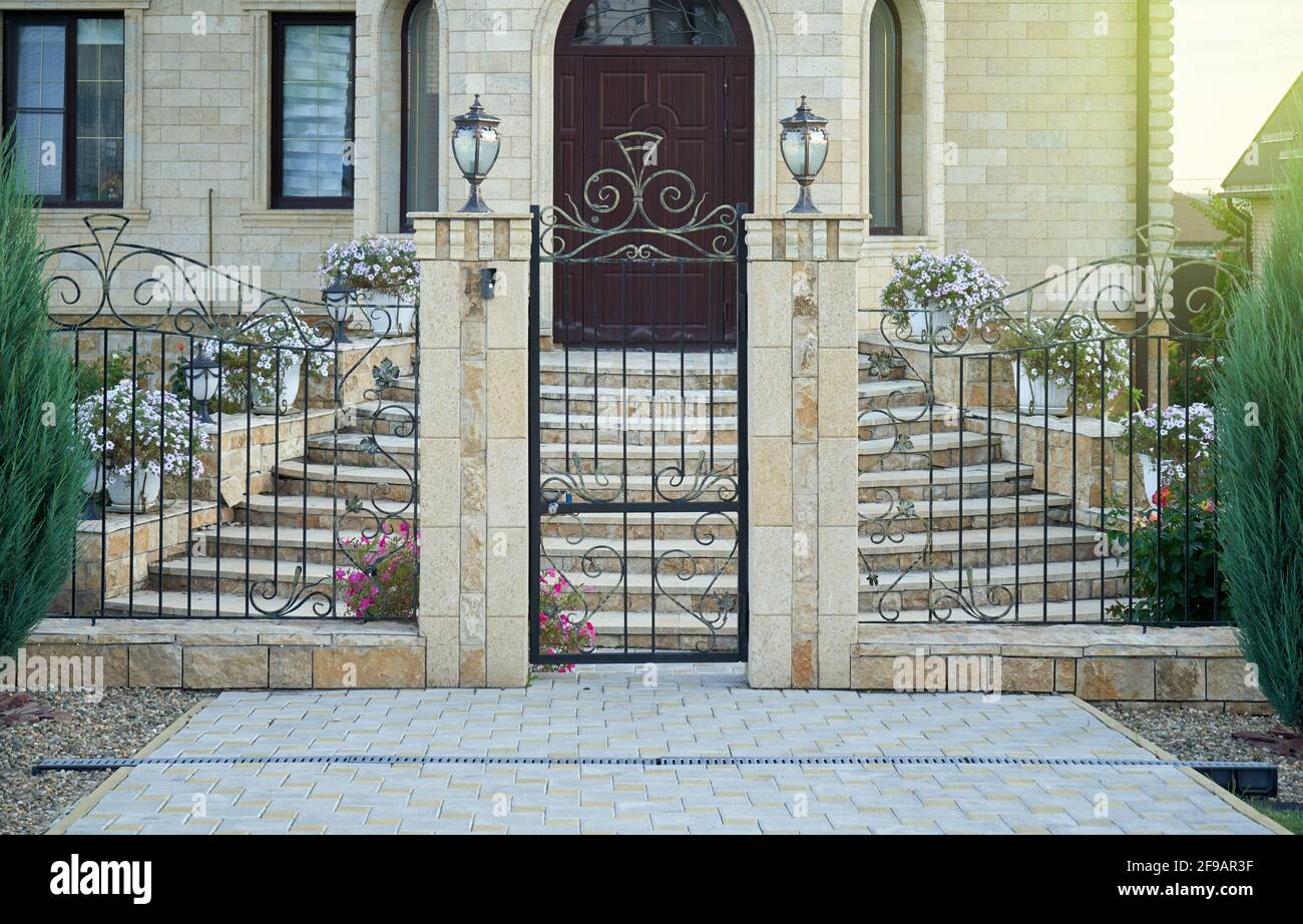 luxury metal forged front door and fence Stock Photo - Alamy