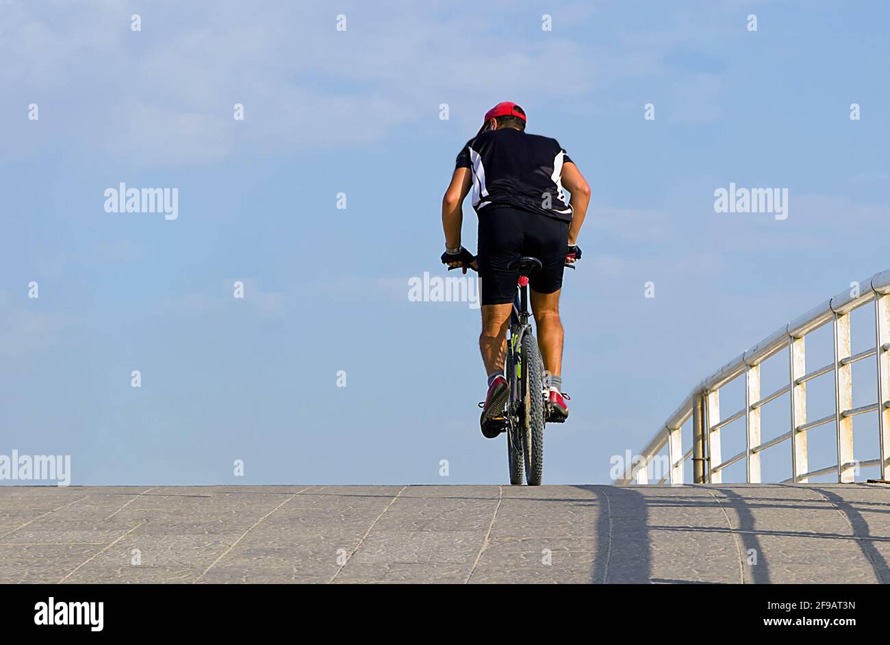 Man cyclist on bike in the city road. Bicycle walk urban slow beauty ...