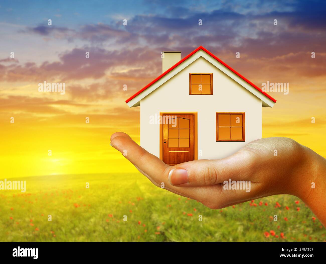 Hand holding small house at sunset. Real estate and property concept ...