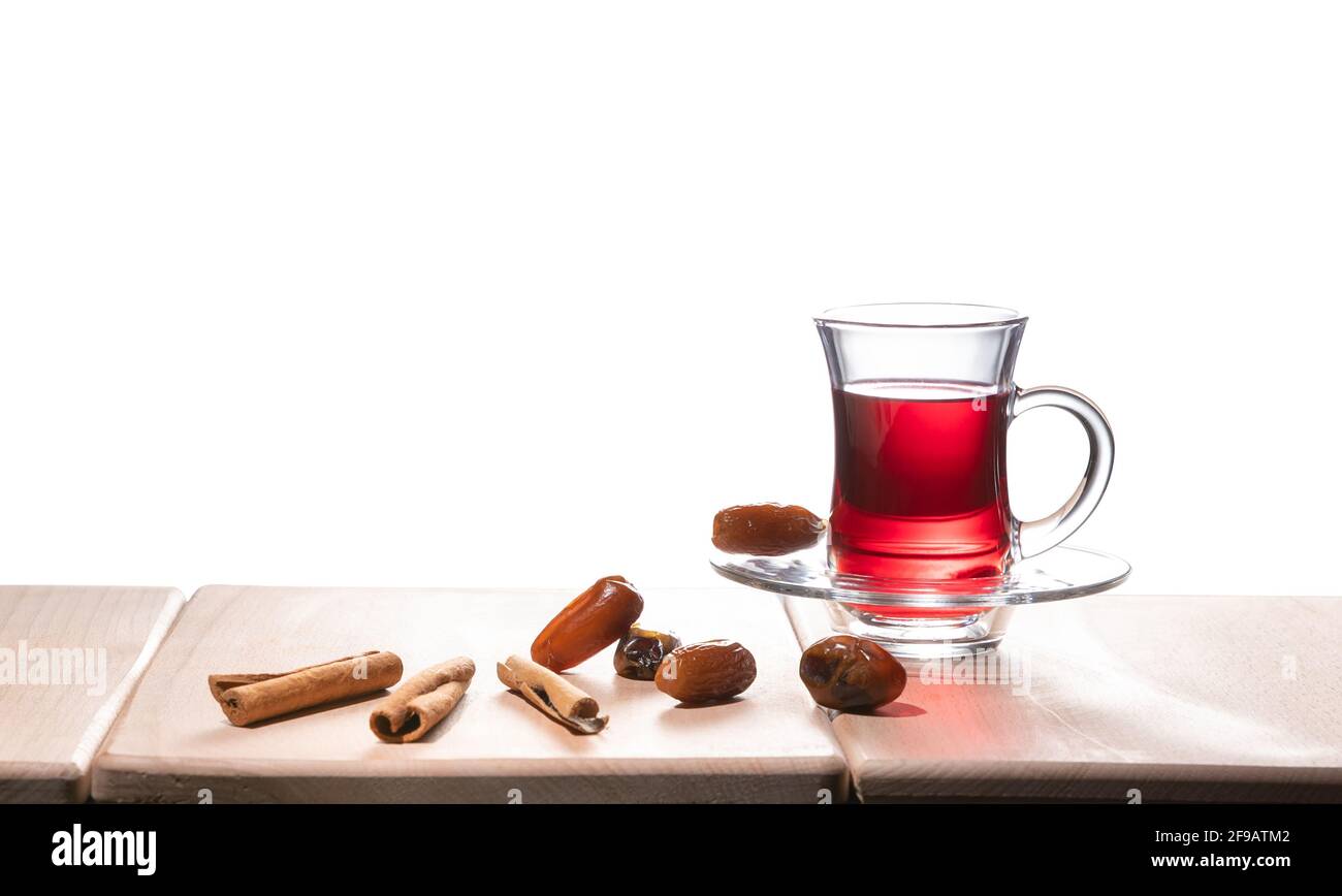 Turkish traditional tea with cinnamon sticks and dates, isolated on ...