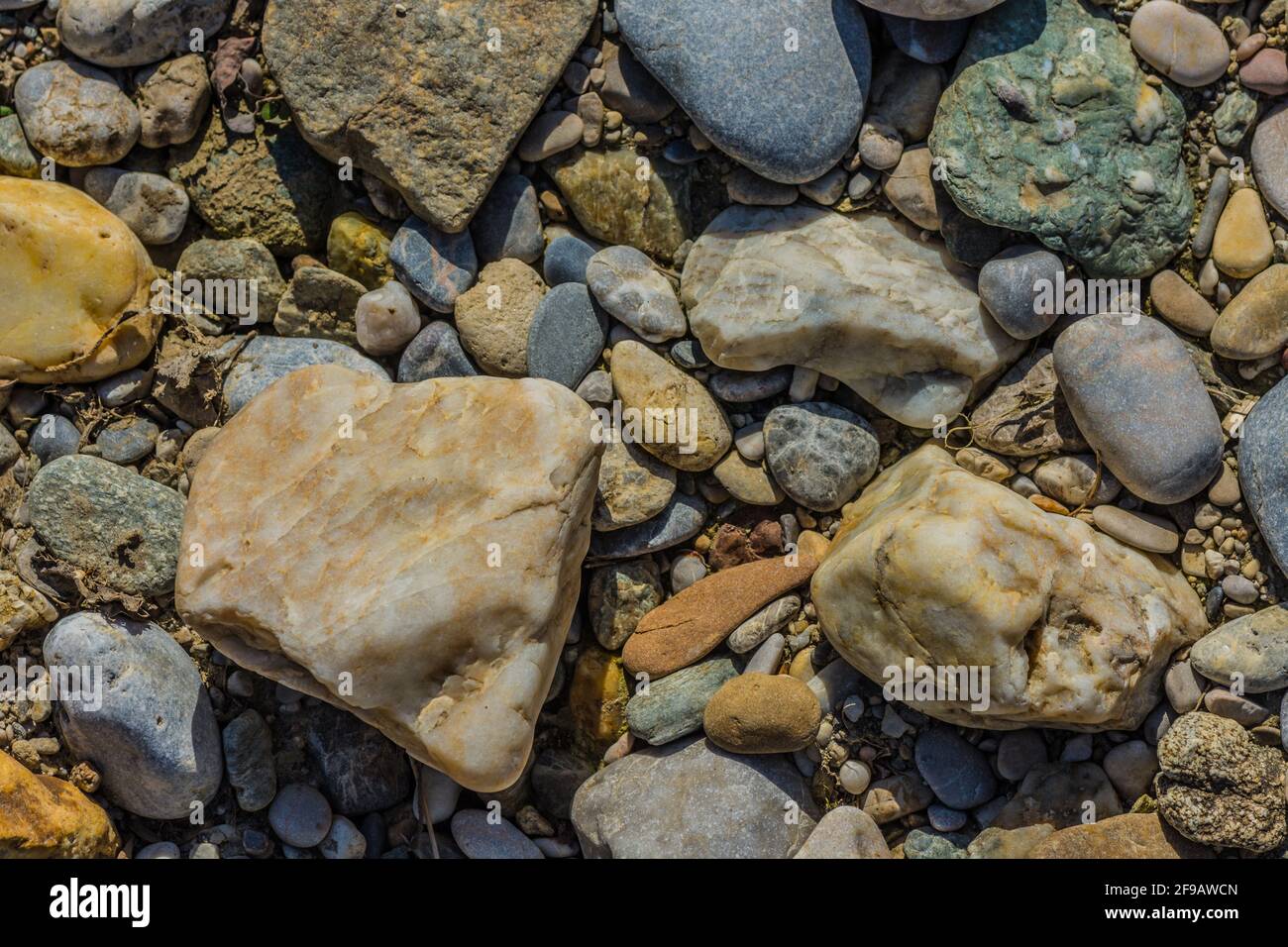 colorful stones from a dried creek in the sun Stock Photo - Alamy