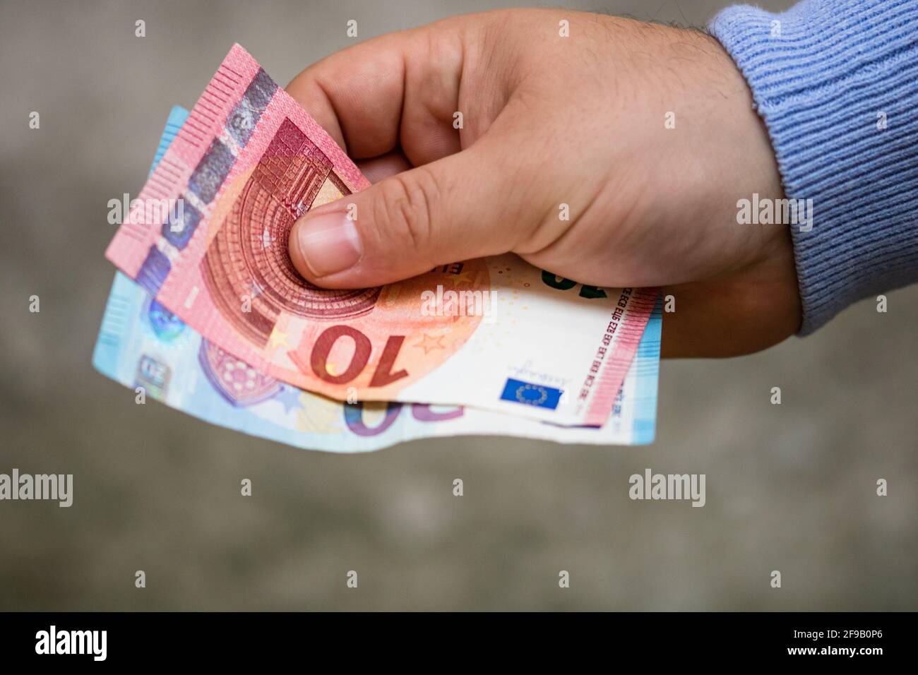 Selective focus on detail of EURO banknotes. Counting or giving EURO ...