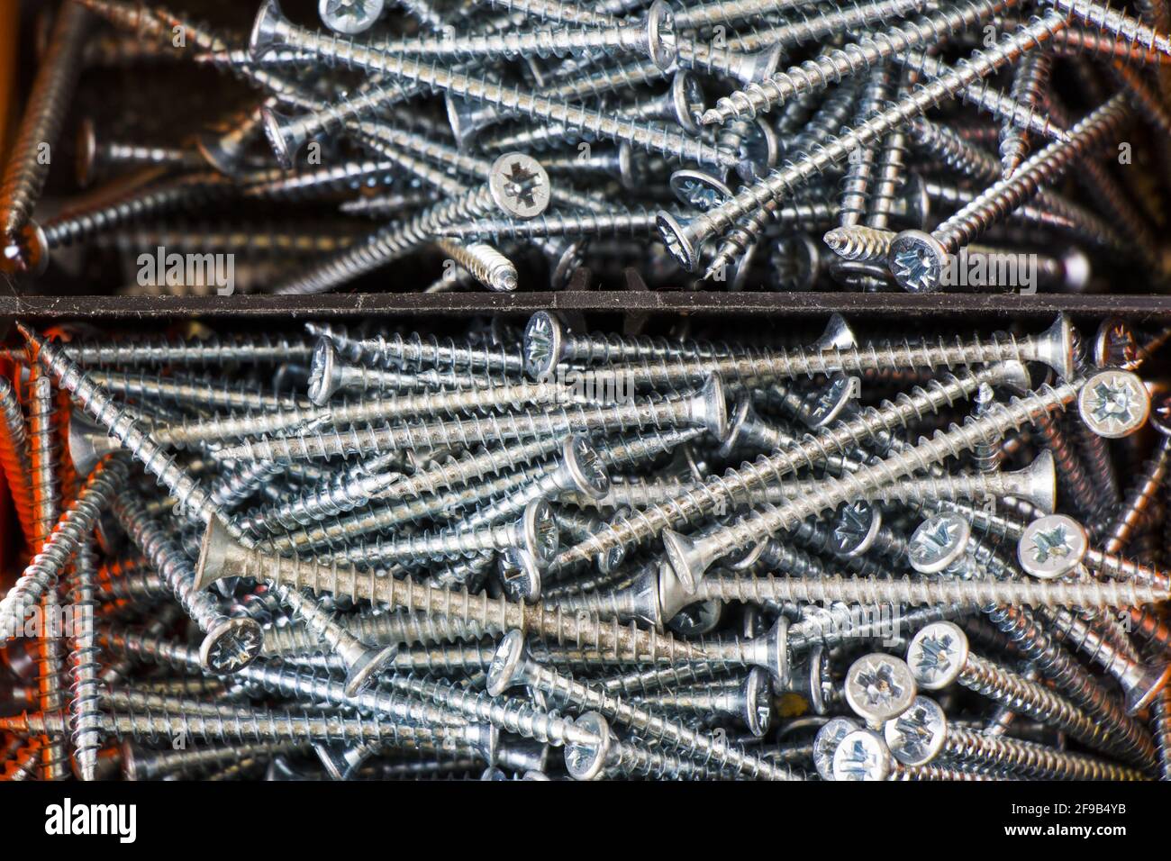 Bunch of screws on a white background Stock Photo - Alamy