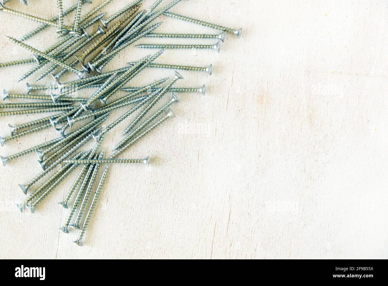 Top view of screws on a white background Stock Photo - Alamy