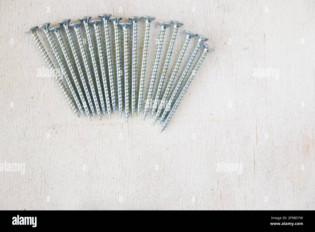 Top view of screws on a white background Stock Photo - Alamy