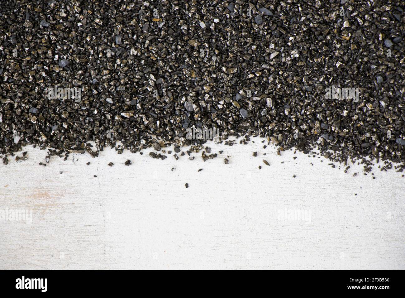 Particles of coal on a white background Stock Photo - Alamy