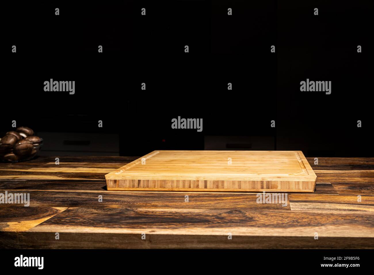 empty wooden tray plate wooden table with dark isolate background ...