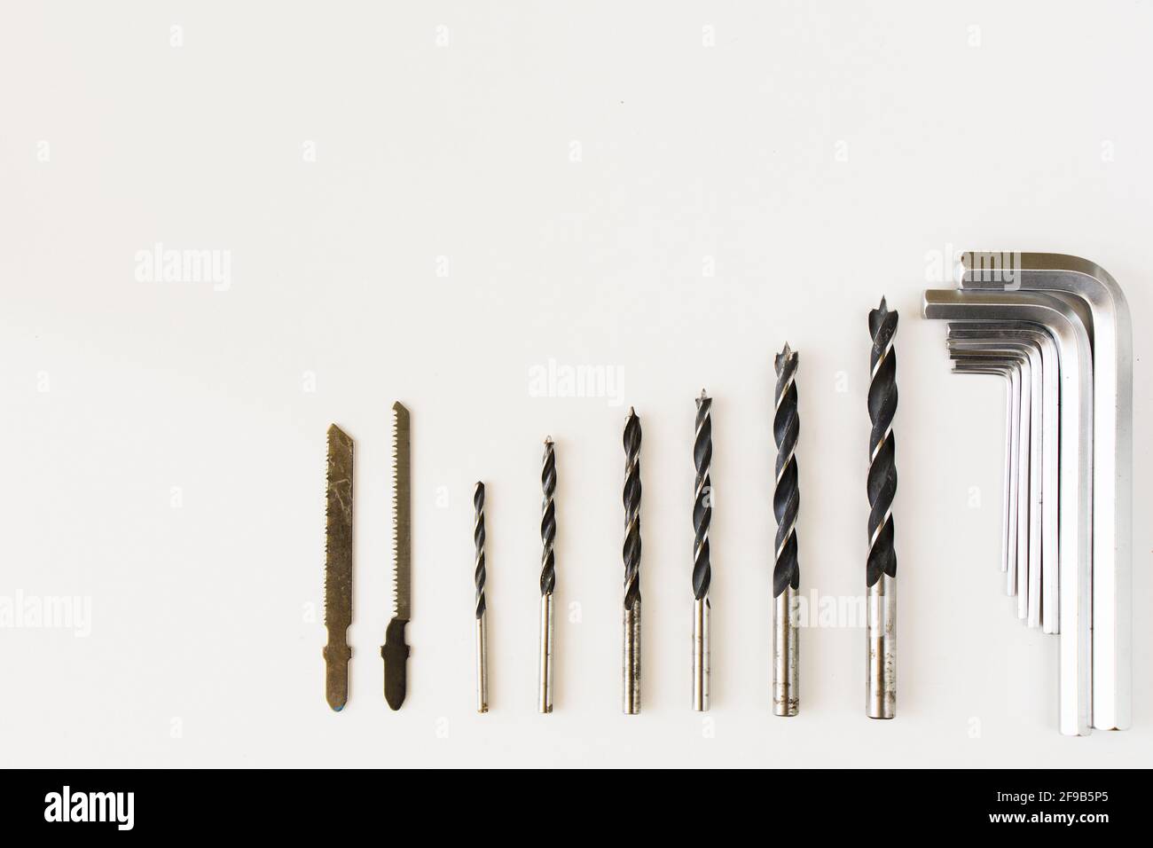 Set of stainless drills and cordless power tools on a white background ...