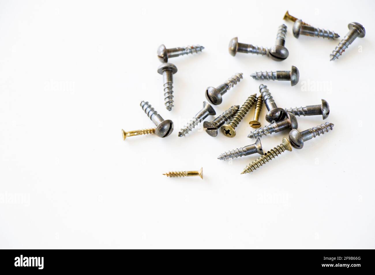 Bunch of different screws and bolts isolated on a white background ...