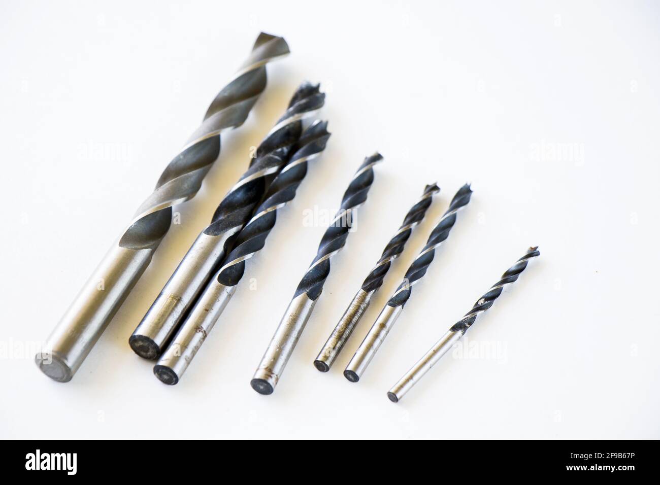 Closeup shot of different sizes of drill bits isolated on white ...