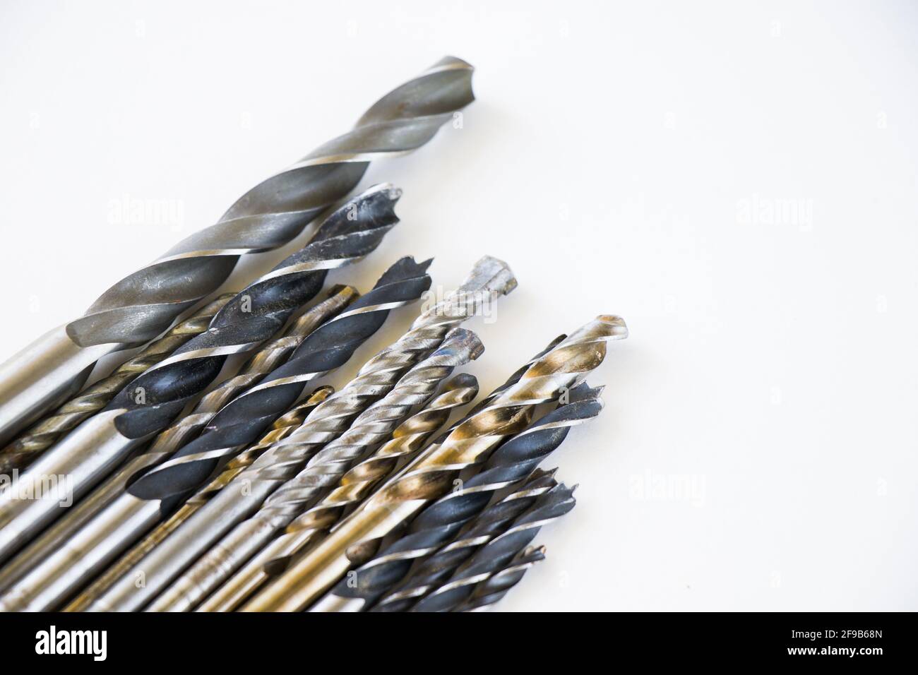 Closeup shot of different sizes of drill bits isolated on white ...