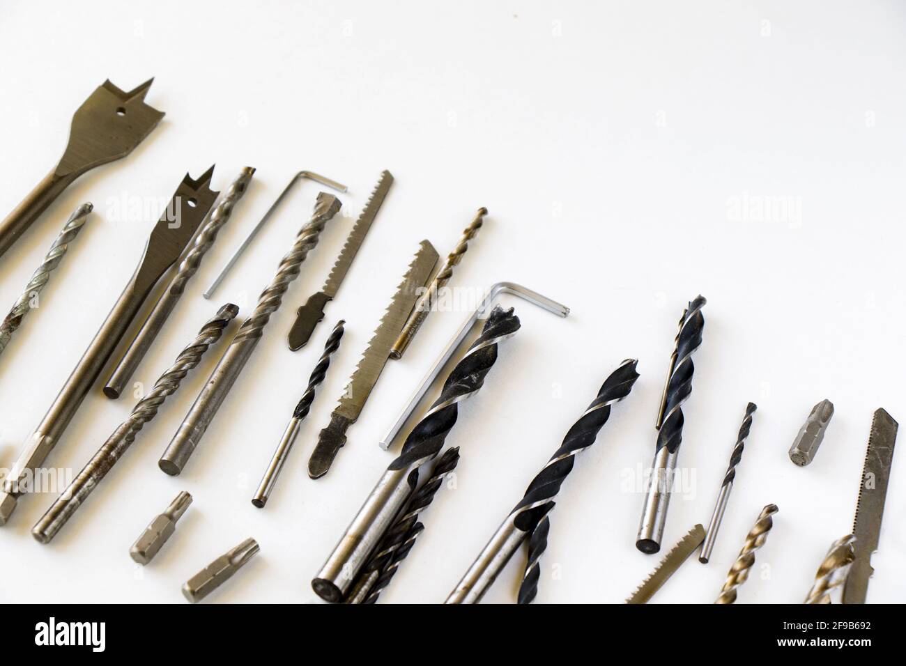 Set of stainless drills and cordless power tools on awhite background ...