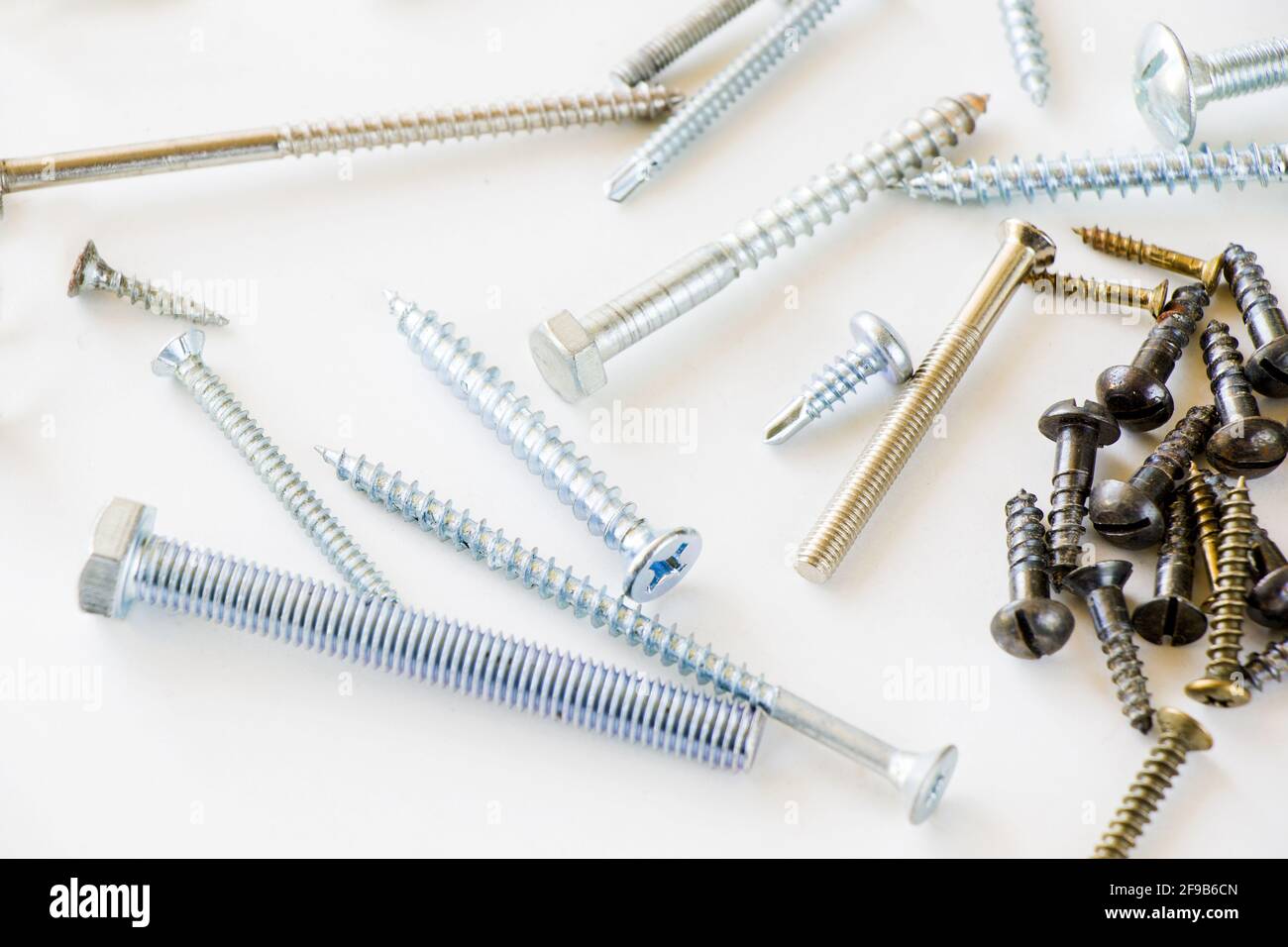 Bunch of different screws and bolts isolated on a white background ...