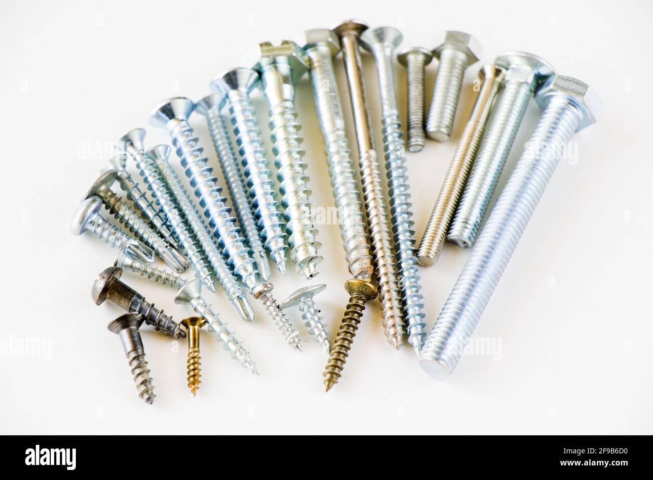 Bunch of different screws and bolts isolated on a white background ...