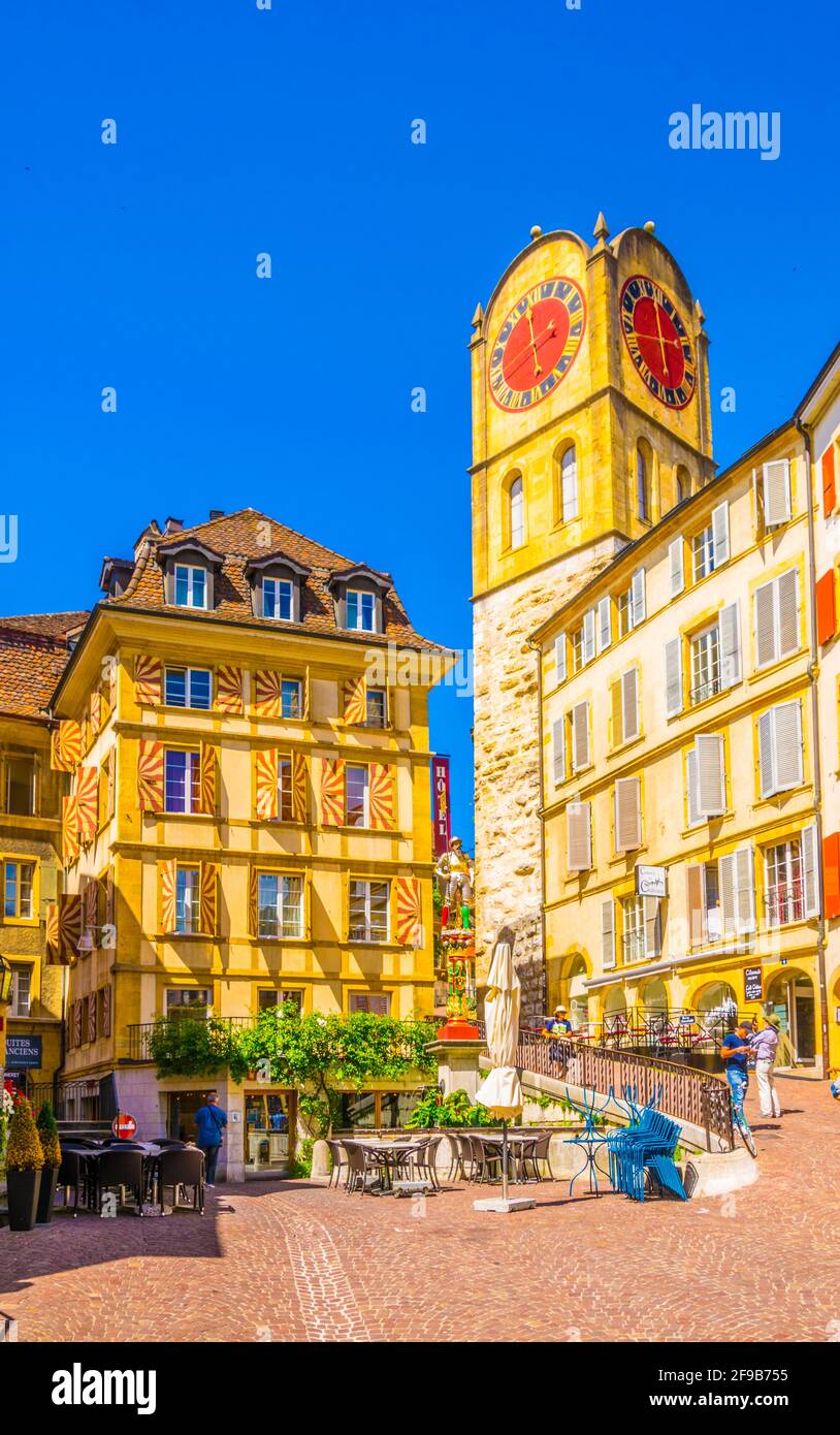 NEUCHATEL, SWITZERLAND, JULY 16, 2017: Banneret square with clock tower ...