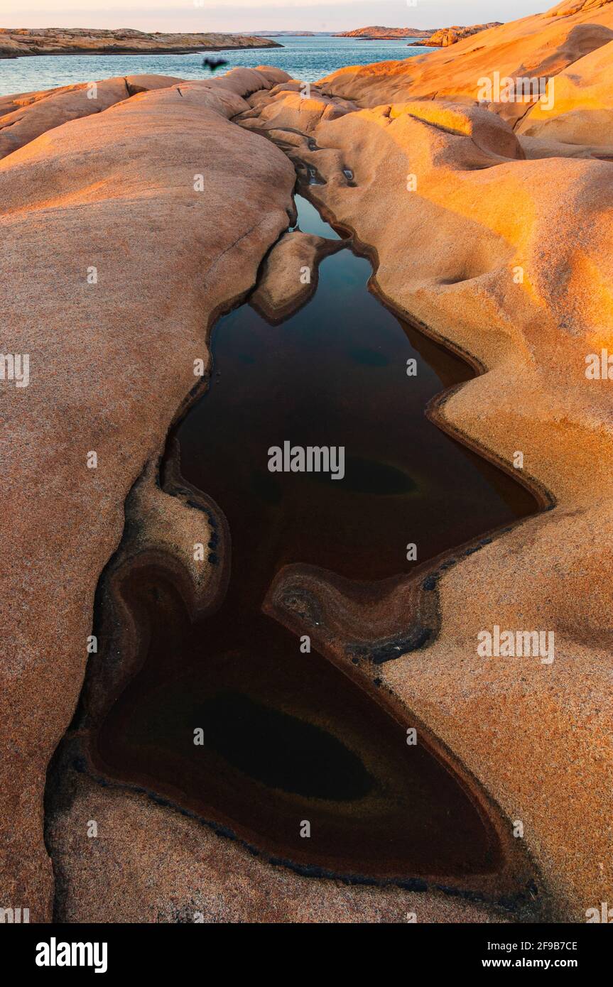 Cliff with water at coast Stock Photo - Alamy