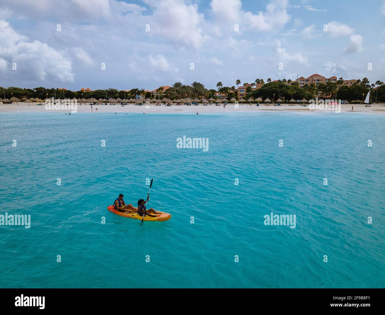 Aruba Caribbean couple men and woman mid age in a kayak in the blue ...