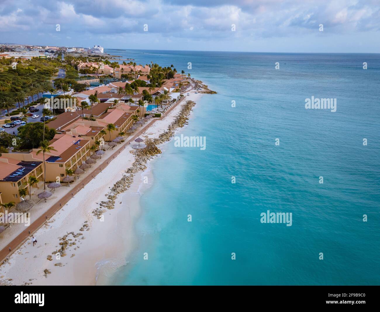 Aruba Caribbean white beach with palm trees and luxury swimming pool ...