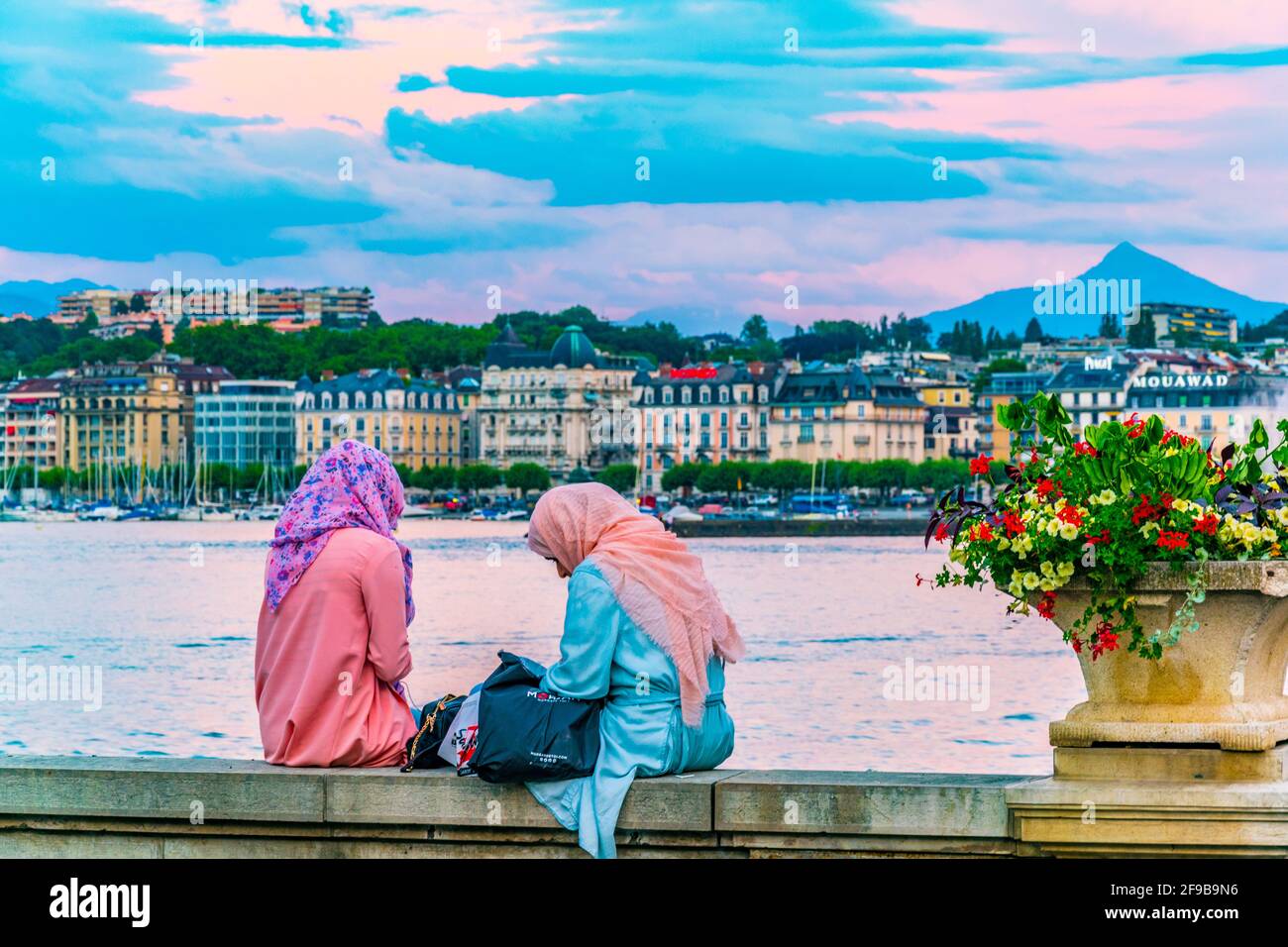 GENEVA, SWITZERLAND, JULY 20, 2017: Two muslim ladies are sitting on a ...