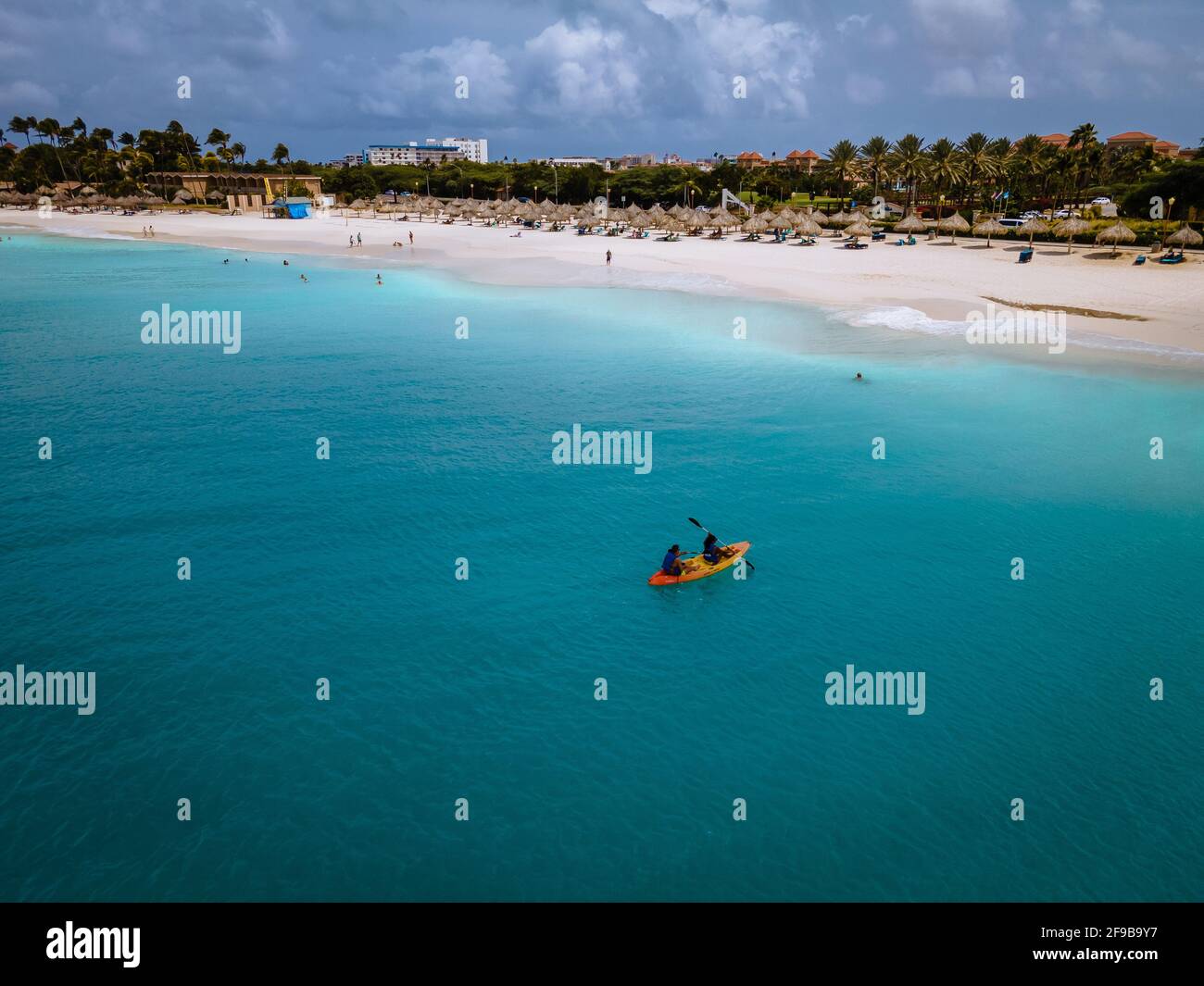 Aruba Caribbean couple men and woman mid age in a kayak in the blue ...