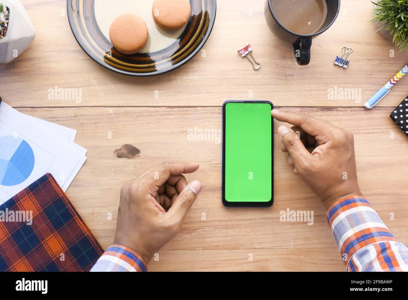 top view of man hand using smart phone on office desk Stock Photo - Alamy