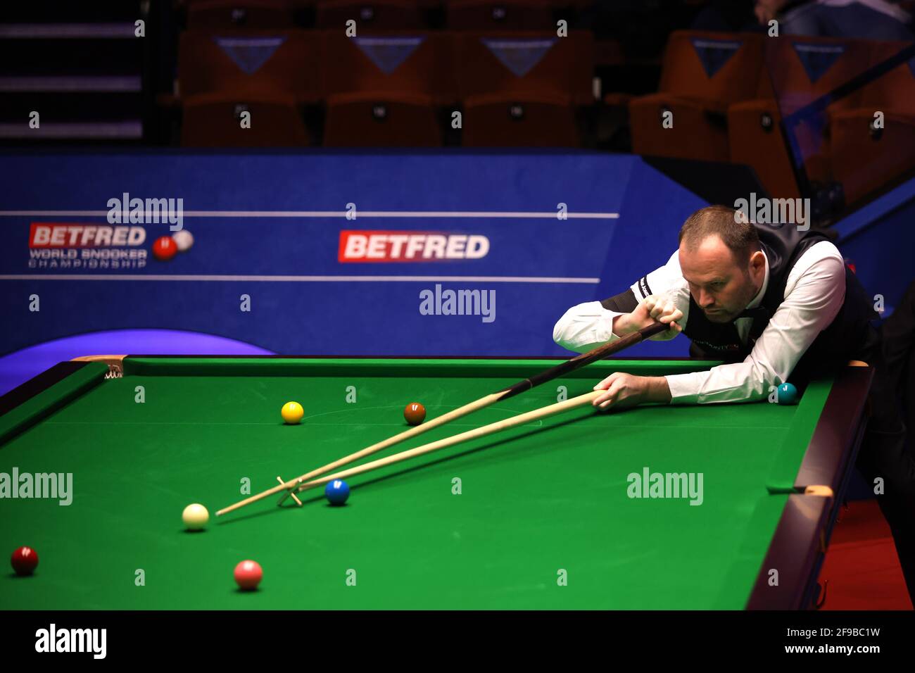 Mark Joyce plays a shot during the Betfred World Snooker Championships ...