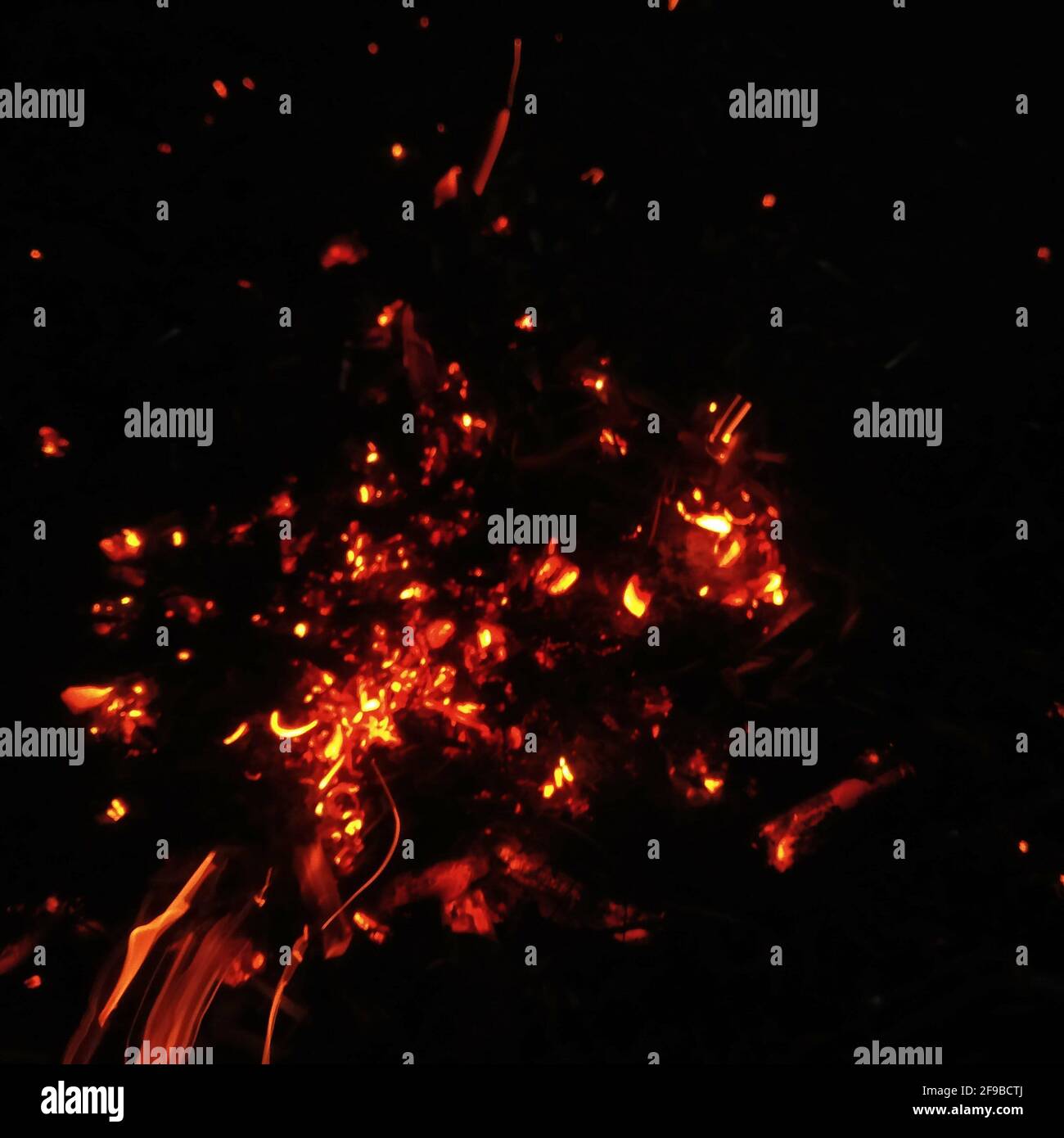 Beautiful shot of fire flames with sparks glowing in the darkness Stock ...