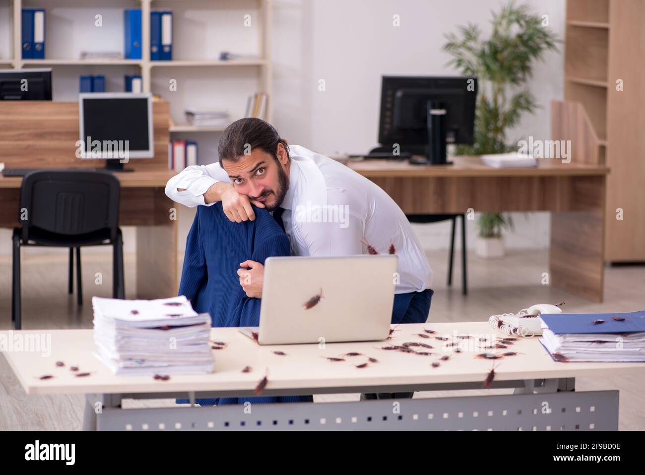 Young businessman employee and too many cockroaches in the office Stock ...