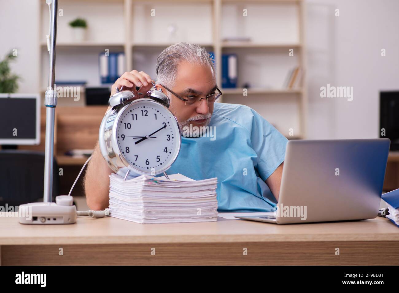 Old businessman employee in blood transfusion concept Stock Photo - Alamy