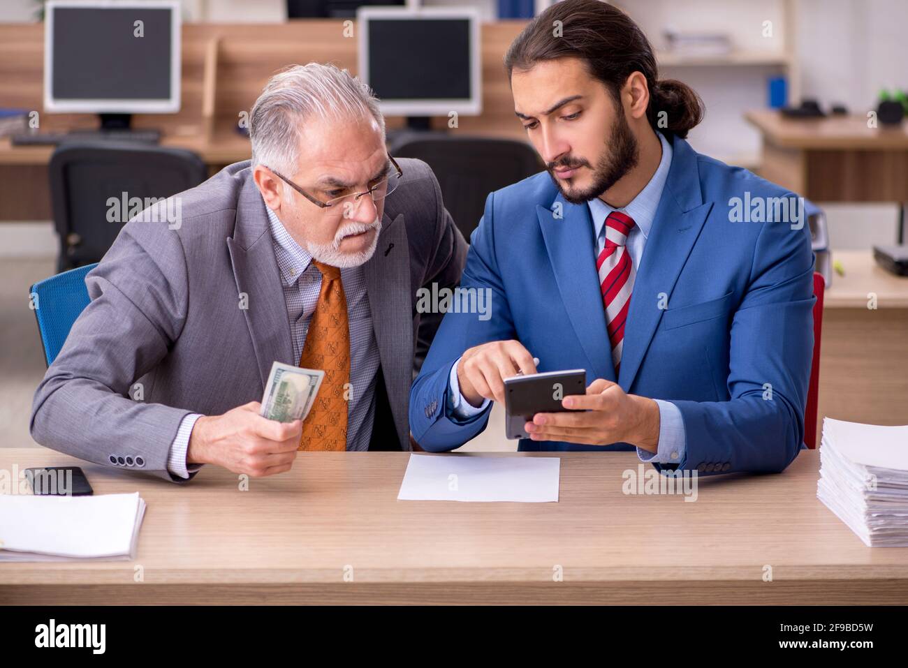Two employees in remuneration concept Stock Photo - Alamy