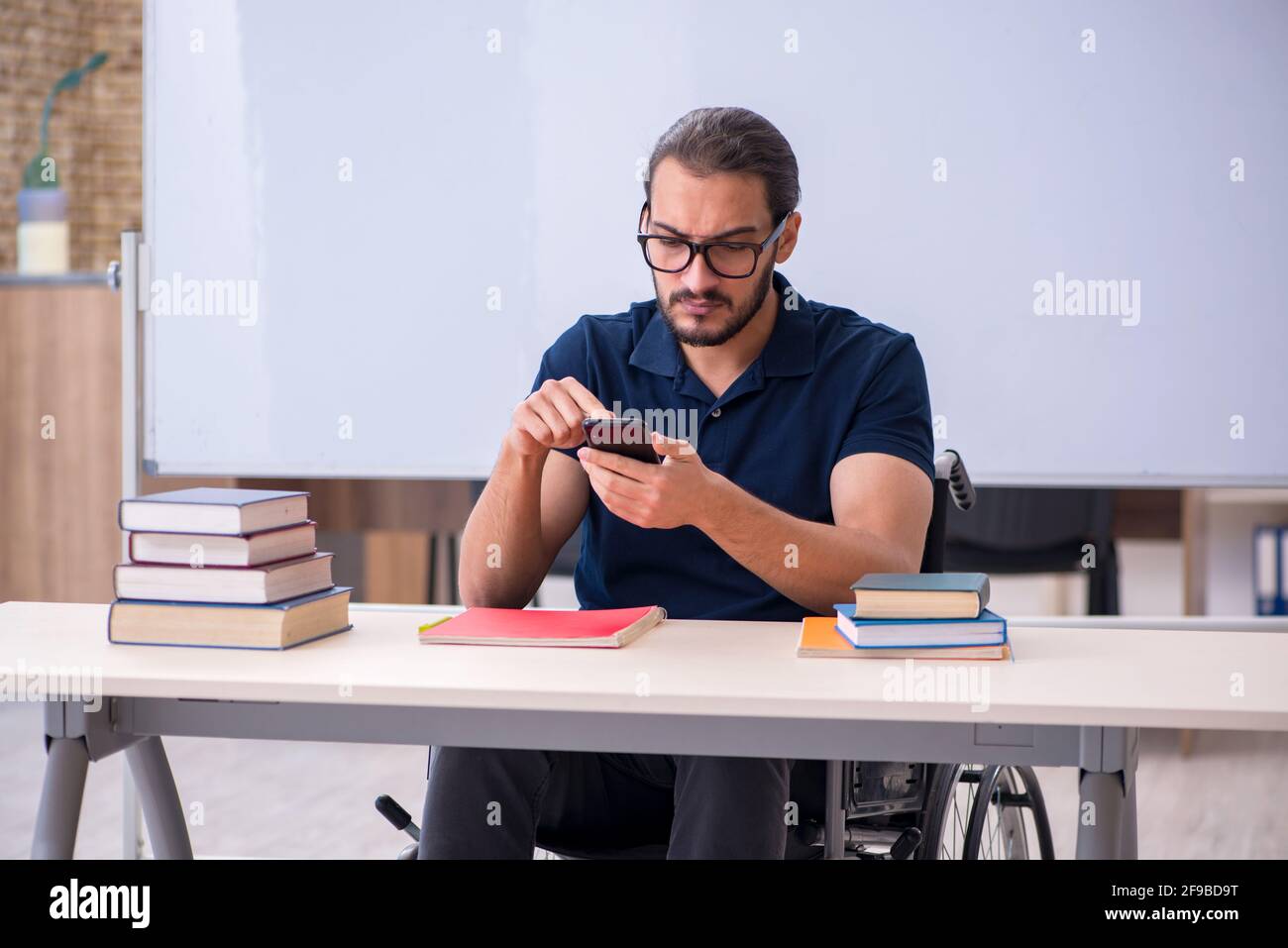 Young handicapped student in the classroom Stock Photo - Alamy